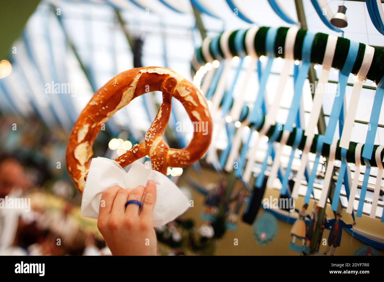Hand Holding pretzel In The Air Stock Photo - Alamy