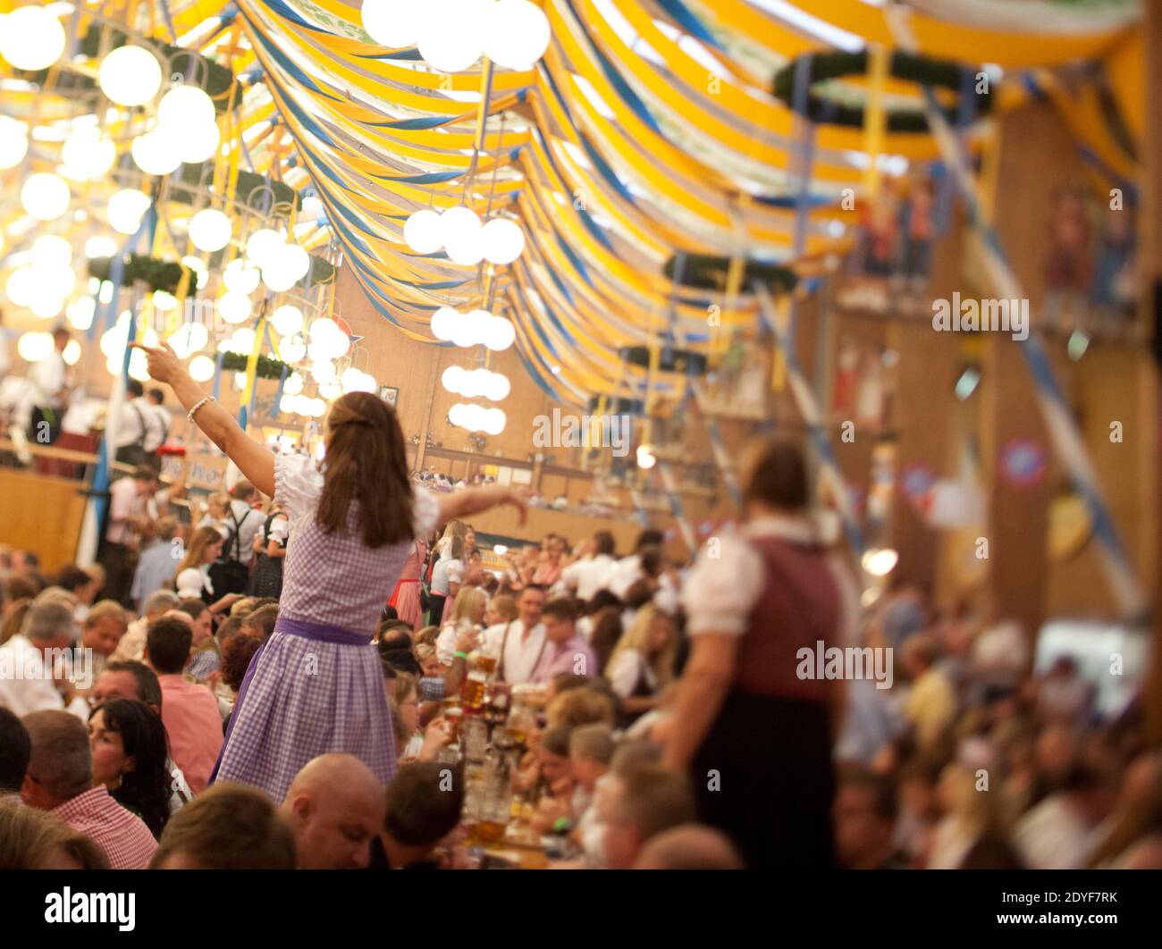 Revelers at Octoberfest on the Theresienwiese in Munich: A Lone Girl ...
