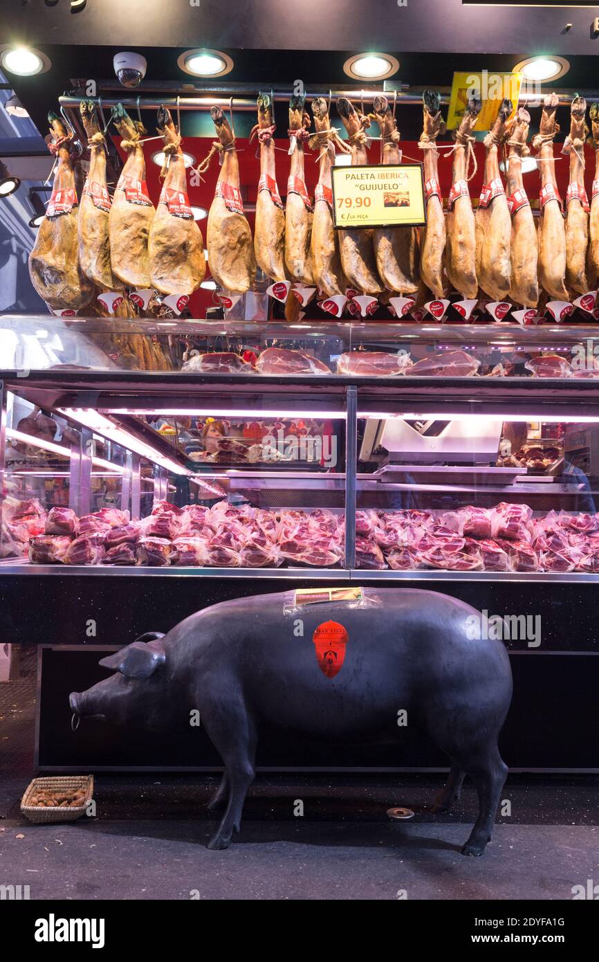 Jamon Iberico, the traditional cured ham hangs at a stand inside ...