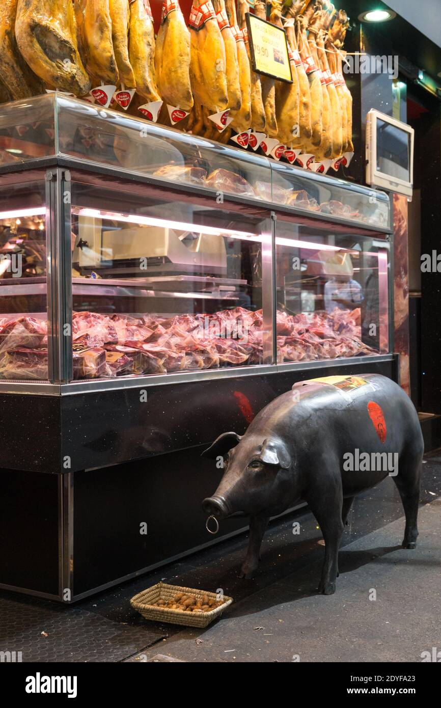 Jamon Iberico, the traditional cured ham hangs at a stand inside ...