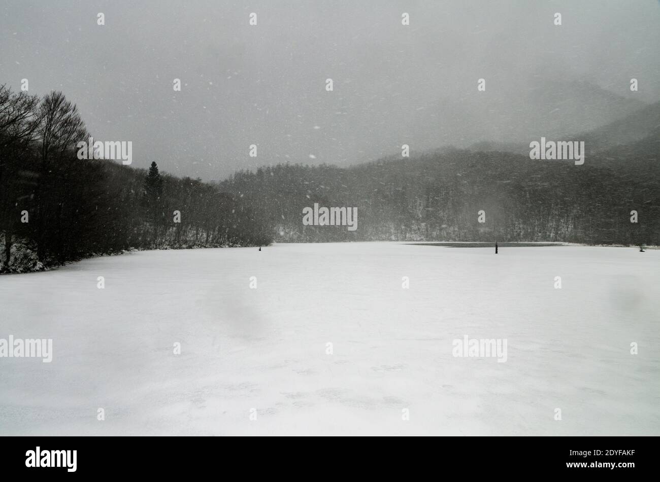 Kagami-ike pond in Nagano Prefecture of Japan. During winter, snow fall covered on the surface ...