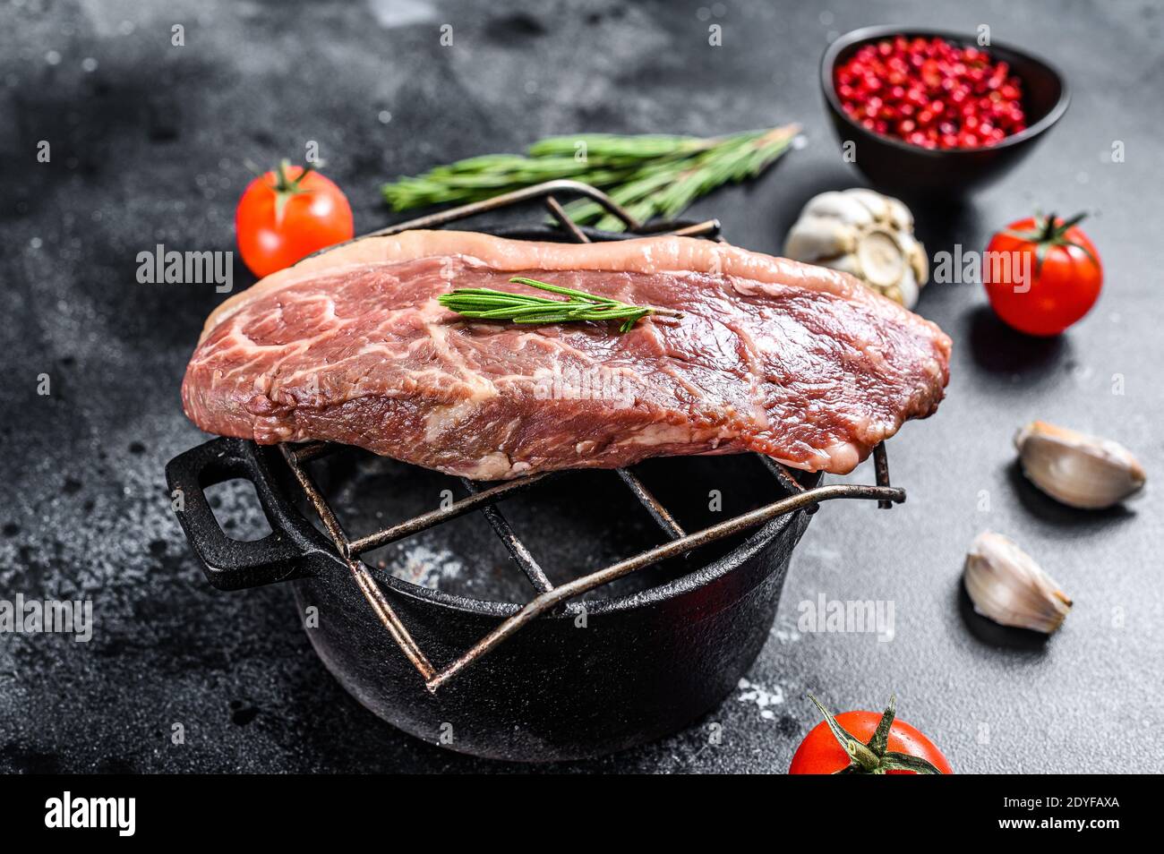 Raw rump cap steak on a grill. Black background. Top view Stock Photo ...