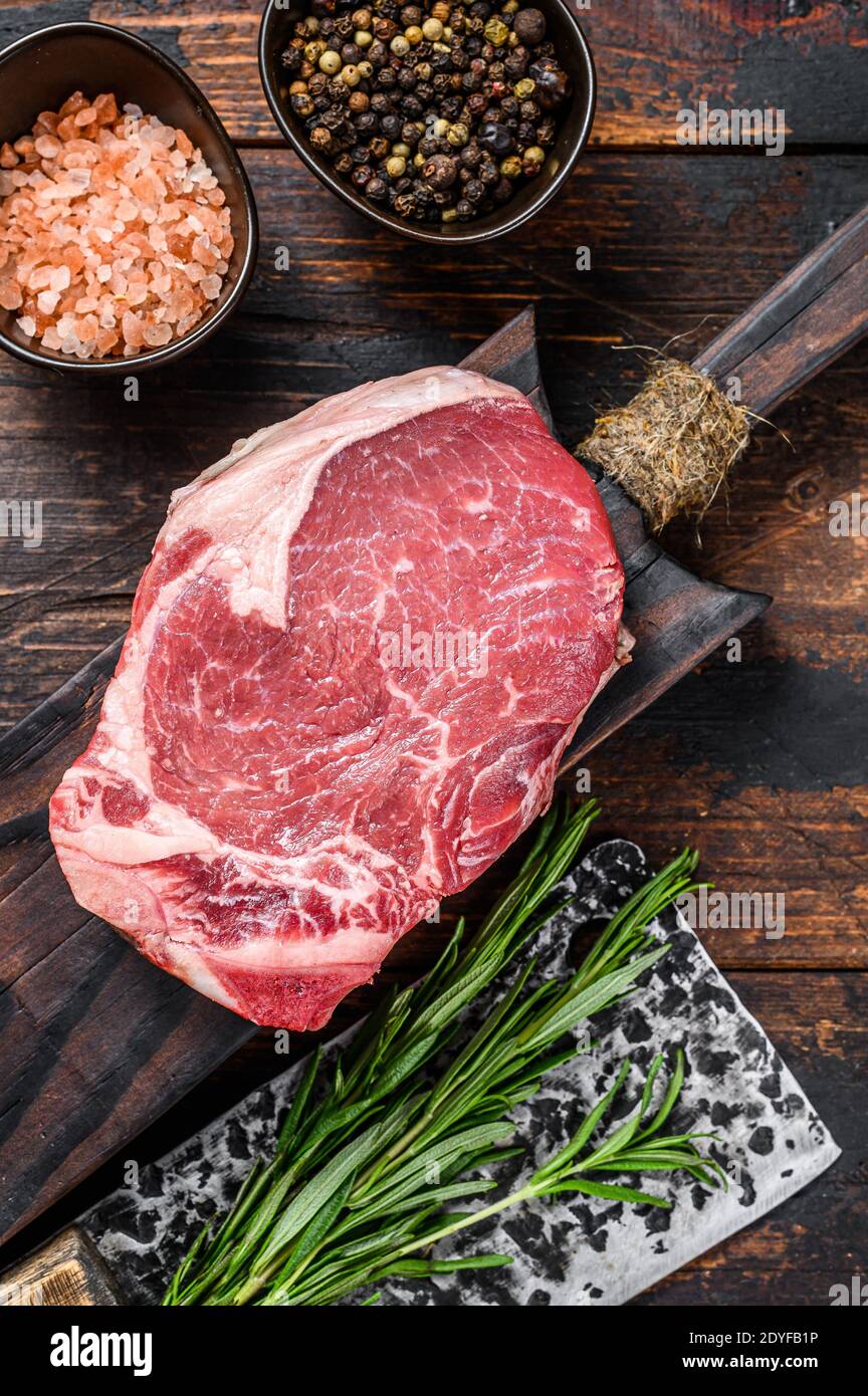 Raw beef meat Club or striploin on the bone steak. Dark wooden ...