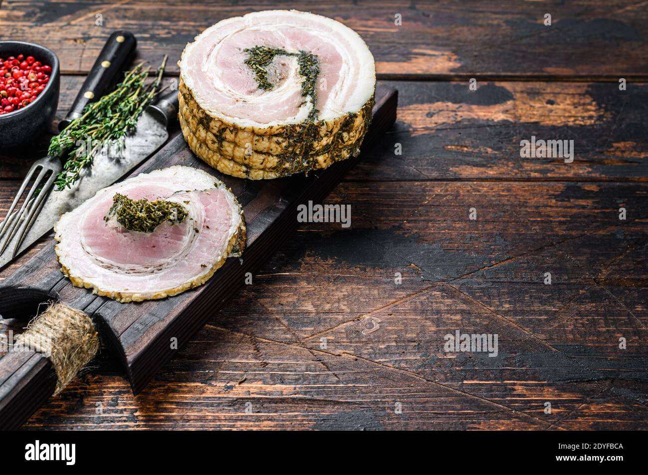 Sliced Italian pancetta on a cutting board. Dark Wooden background. Top ...