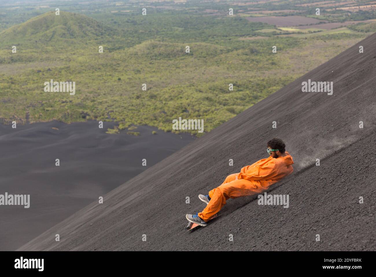 A Volcano surfer slides down Cerro Negro Volcano Stock Photo - Alamy