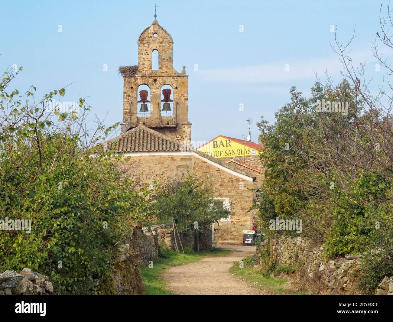 The parish church and the pilgrim hostel in a small Camino village ...