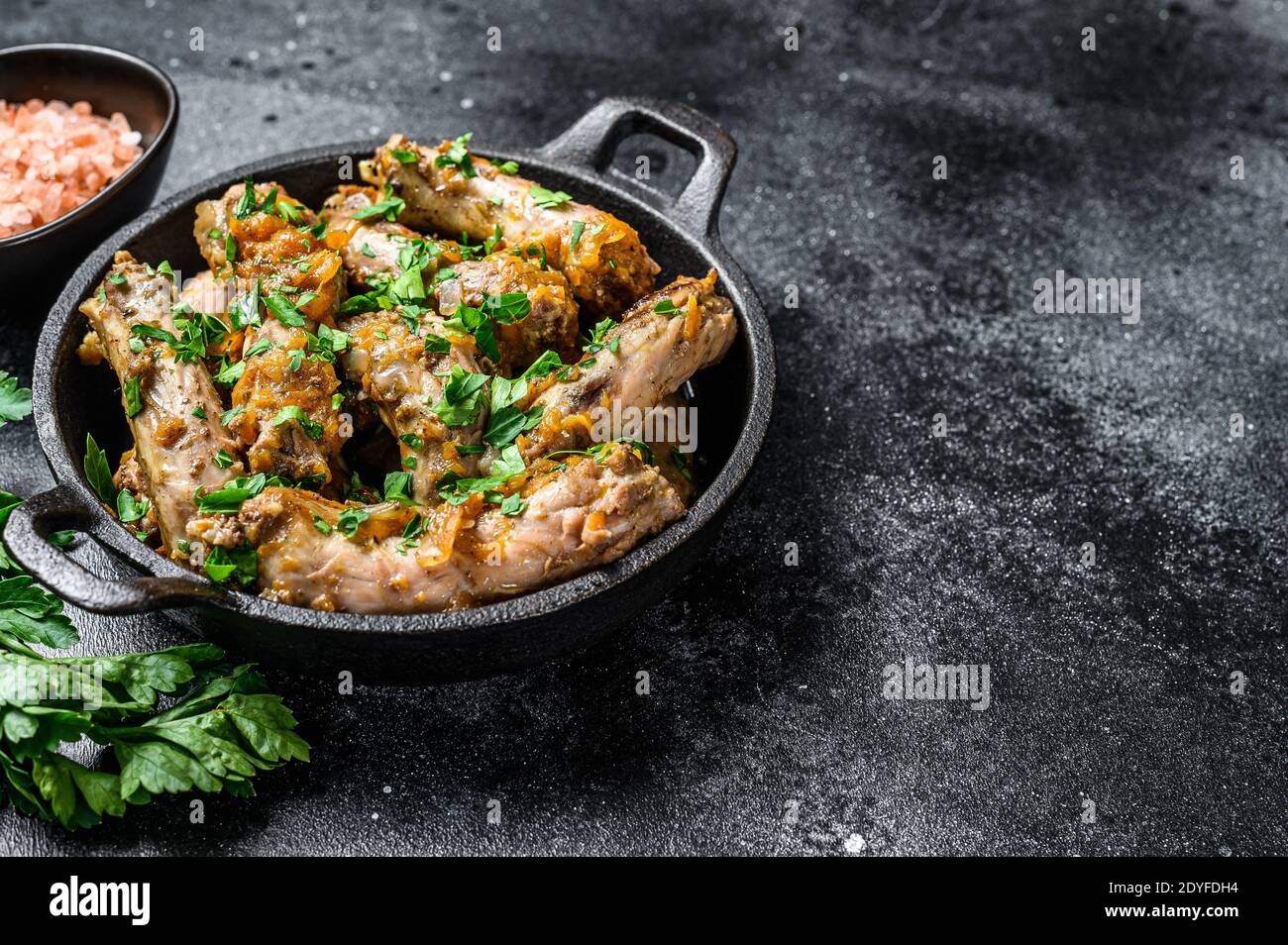 Stew with Chicken Neck meat and vegetables. Black background. Top view ...