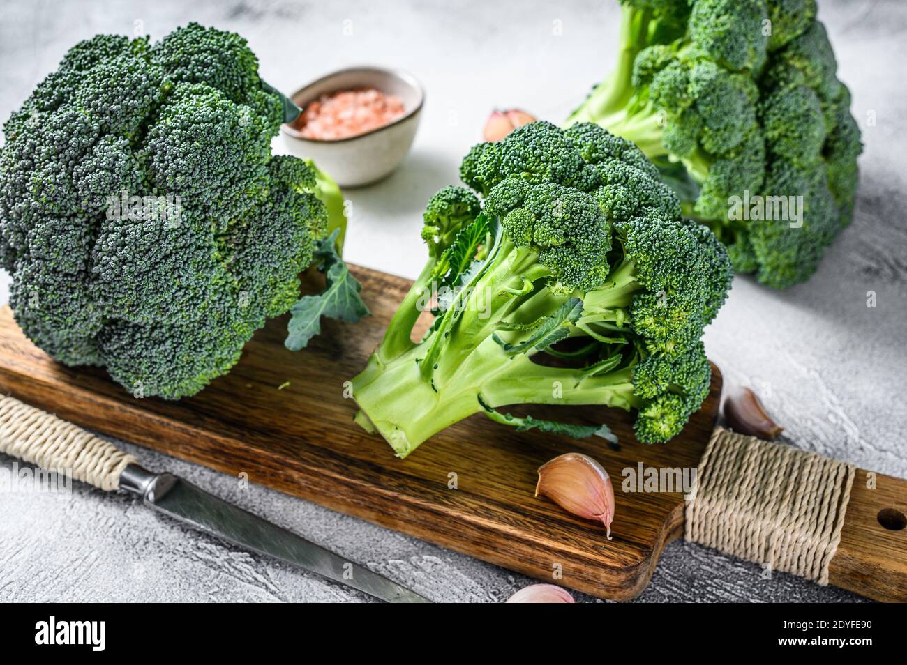 Raw green broccoli cabbage on a wooden cutting board. White background ...
