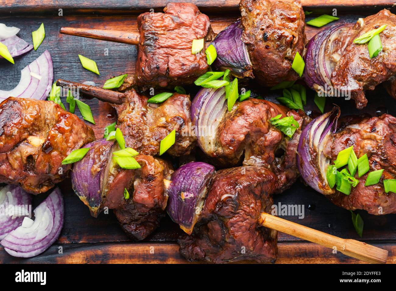 Grilled liver kebab with onion on skewers.Shish kebab on wooden ...