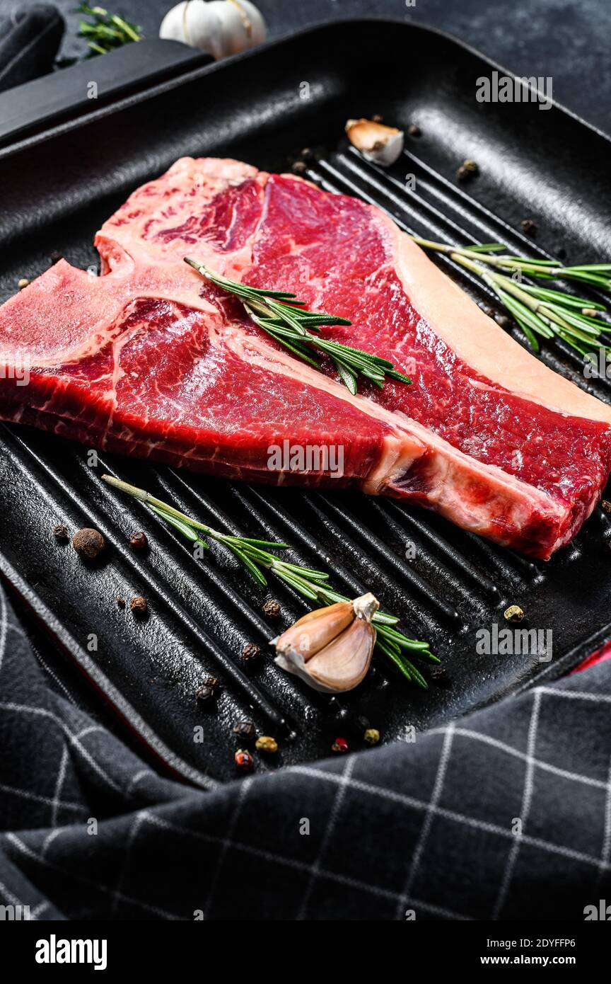 Porterhouse raw steak. Organic meat beef. Black background. Top view ...