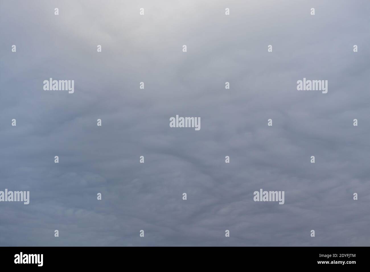 Sun tries to pierce through a build-up of grey storm clouds, with the ...