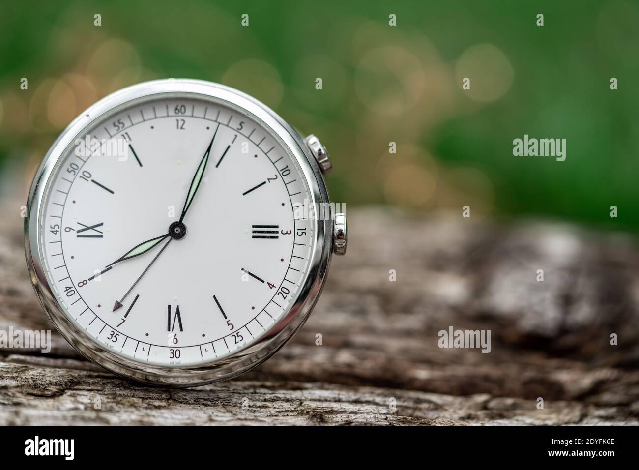 Vintage clock on a wooden background. Old watch as a symbol of passing ...