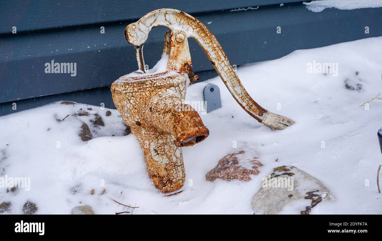A closeup of an old rusty object covered in snow Stock Photo - Alamy