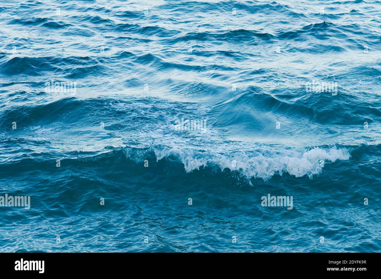 Ripple on the surface of the ocean water close-up. Blue sea background ...