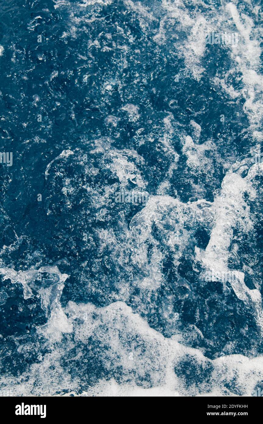 Bubble sea water surface background close-up. Rapid blue splashing ...