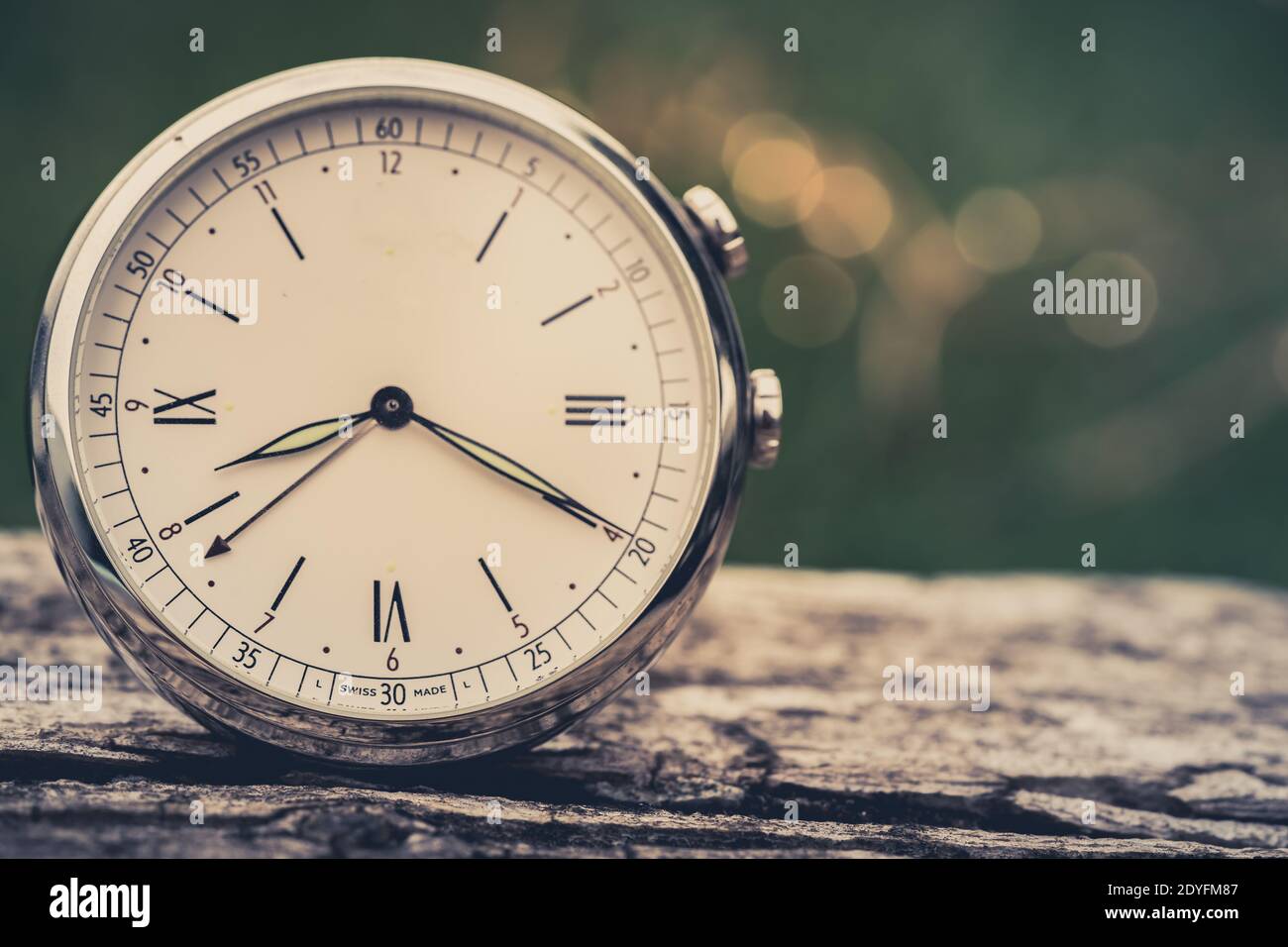 Vintage clock on a wooden background. Old watch as a symbol of passing ...