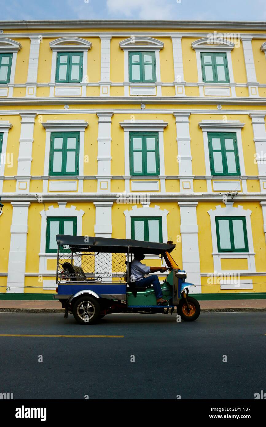 A tuk tuk in the street of bangkok with an architectural view of with ...