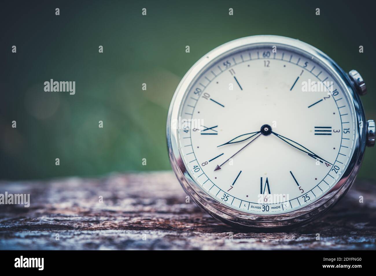 Vintage clock on a wooden background. Old watch as a symbol of passing ...