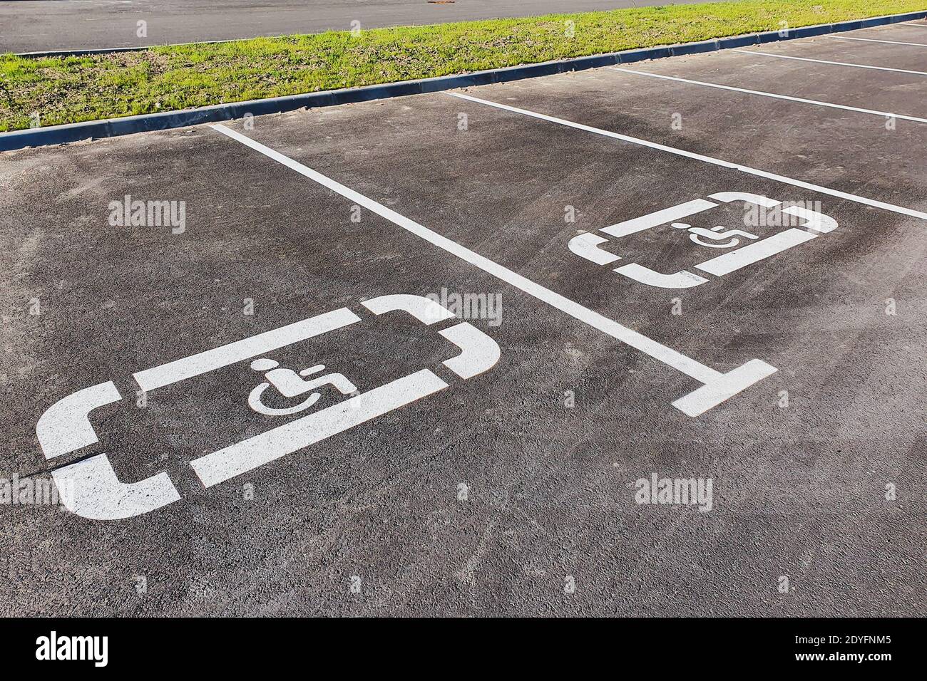 New disabled person sign painted on the new asphalt. Close up view ...