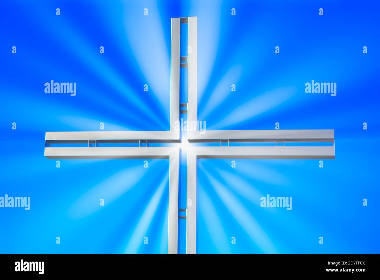 Cross in sun rays . Religious symbol with blue sky on background ...