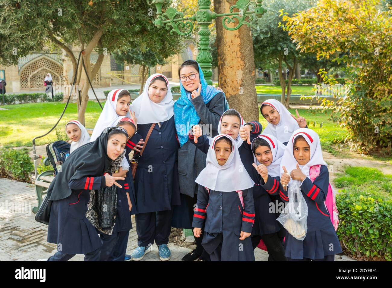 A Chinese young girl standing inside of a group of Iran primary ...
