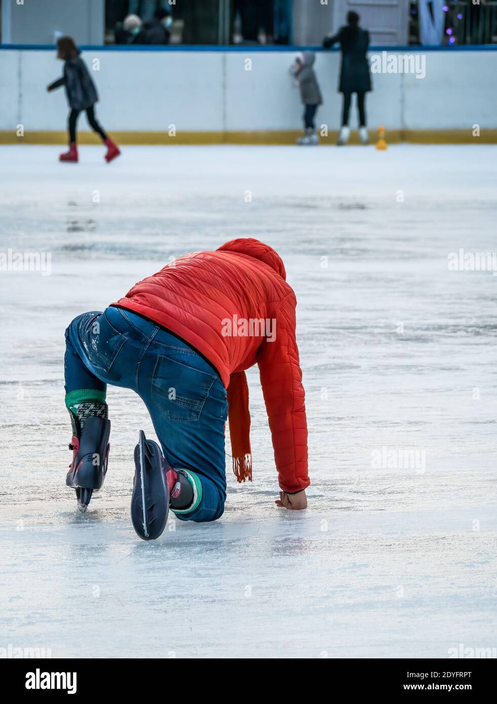 Man on ice skates falling on the ice rink in Cismigiu park, in ...