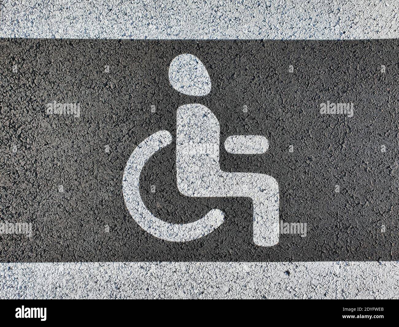 New disabled person sign painted on the new asphalt. Close up view ...