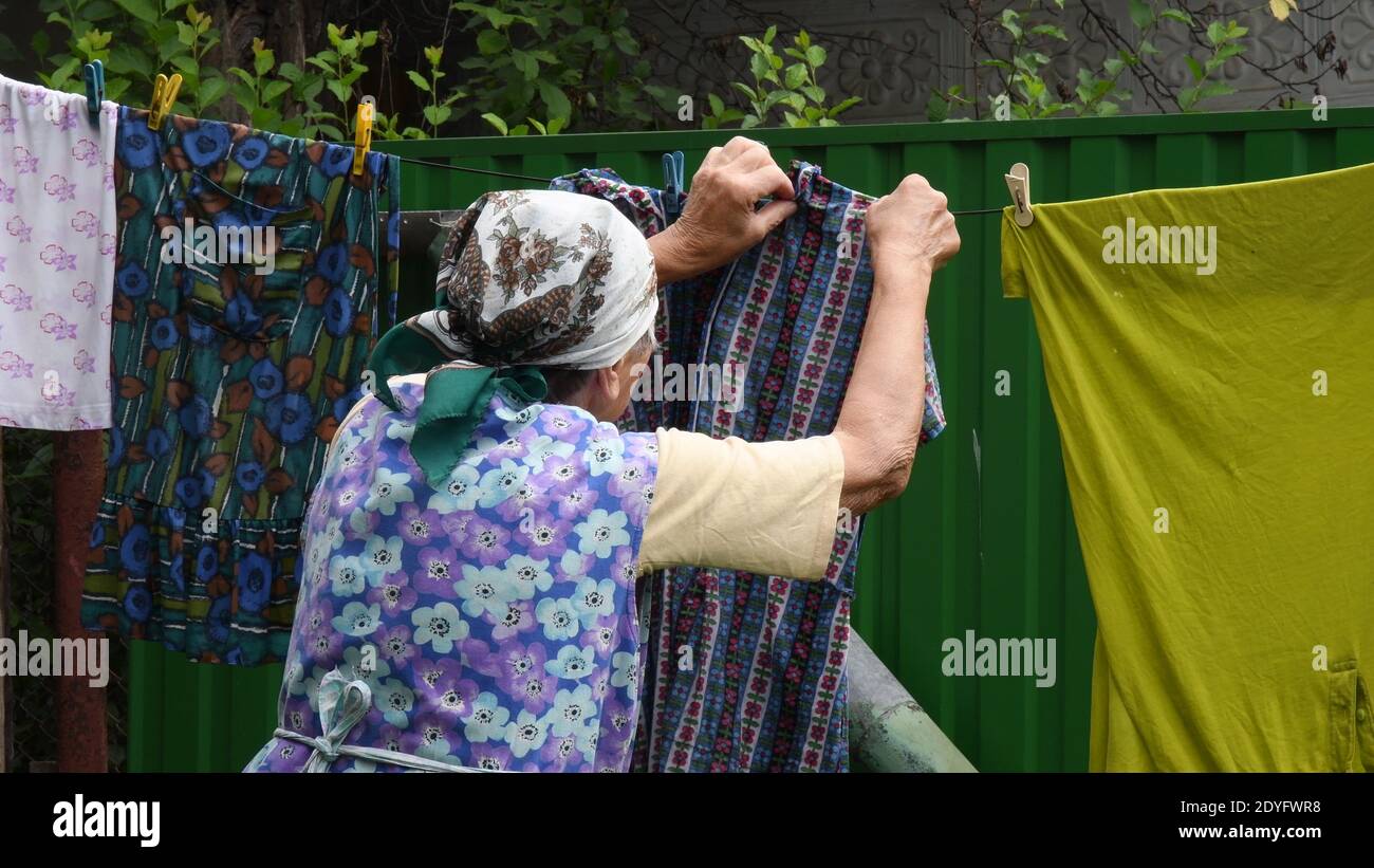 Great-grandmother with traditional head scarf on her head spreading and ...