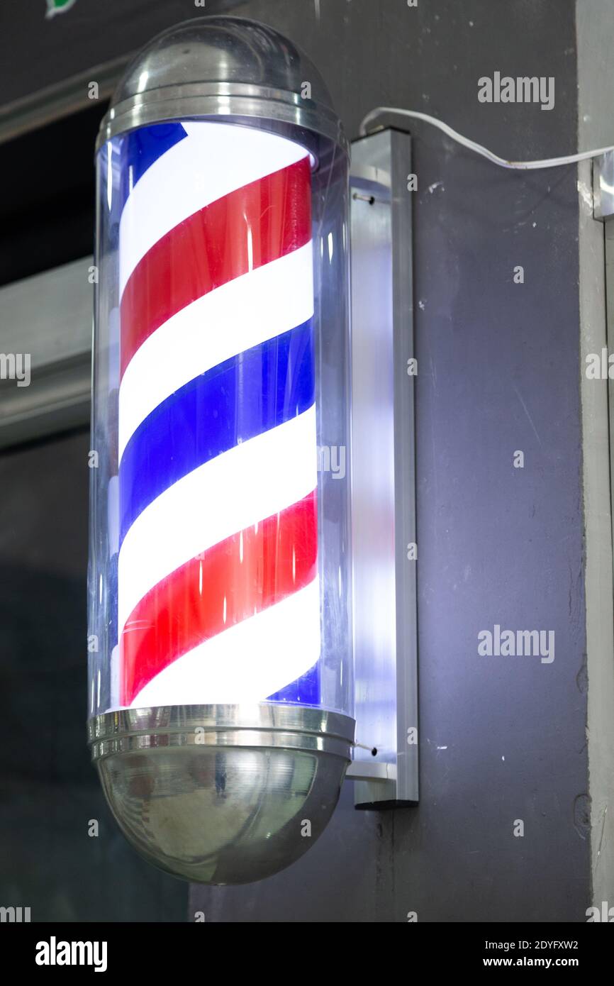 A vertical shot of a Barber's pole Stock Photo - Alamy