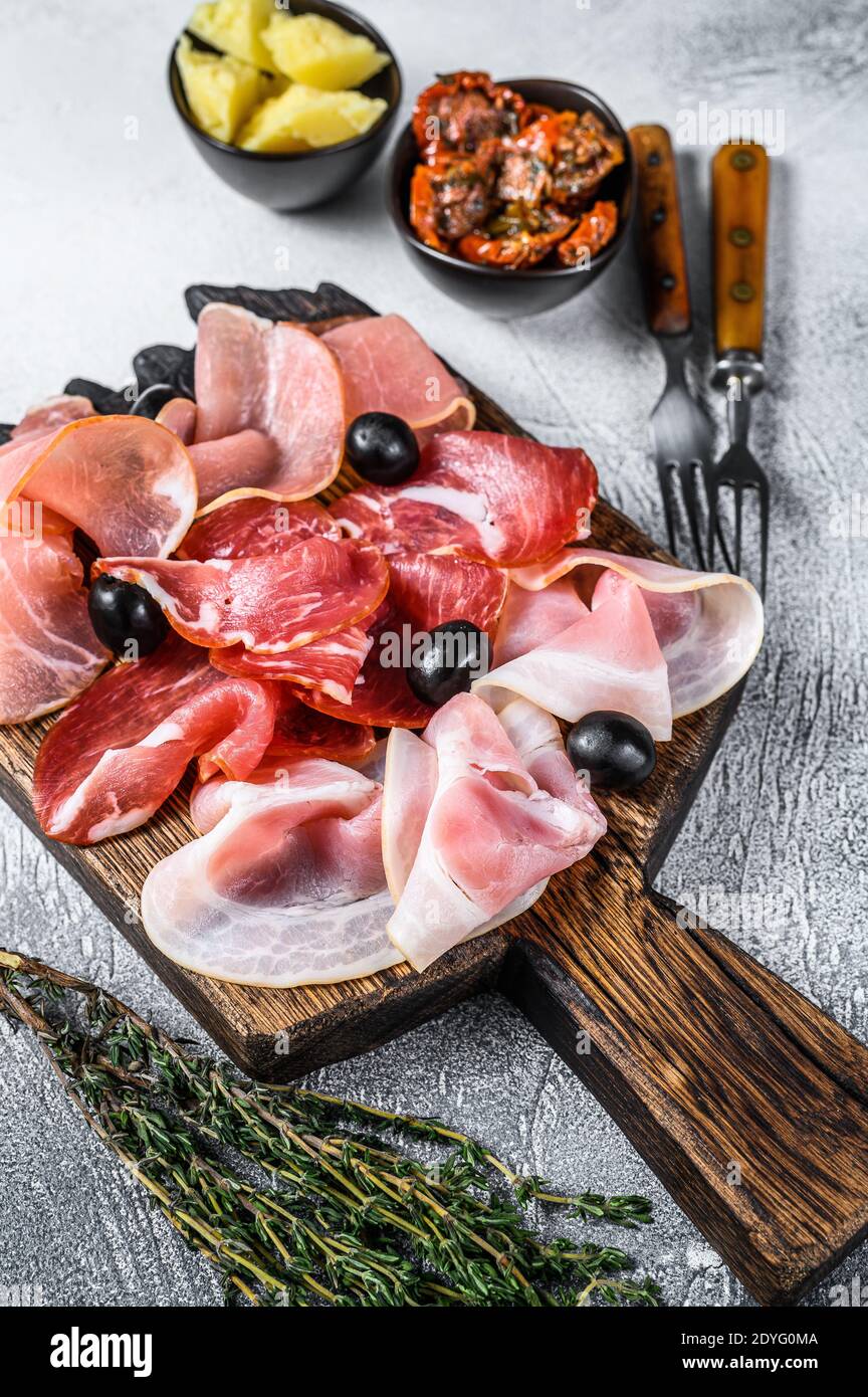 Cured meat platter of traditional Spanish tapas. White background. Top ...