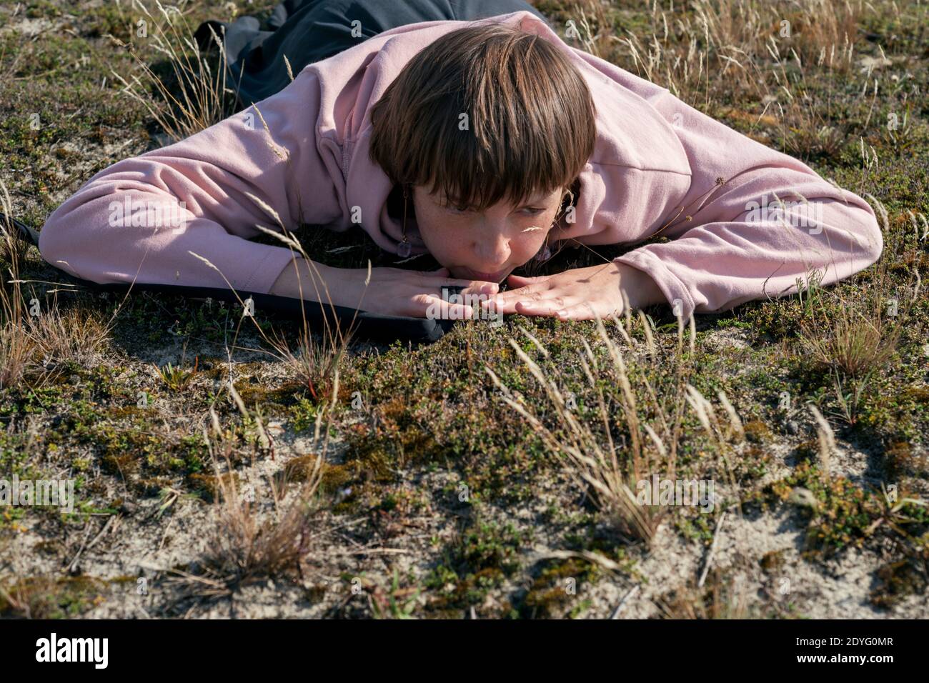 Woman lying on the ground, intimacy with nature Stock Photo - Alamy