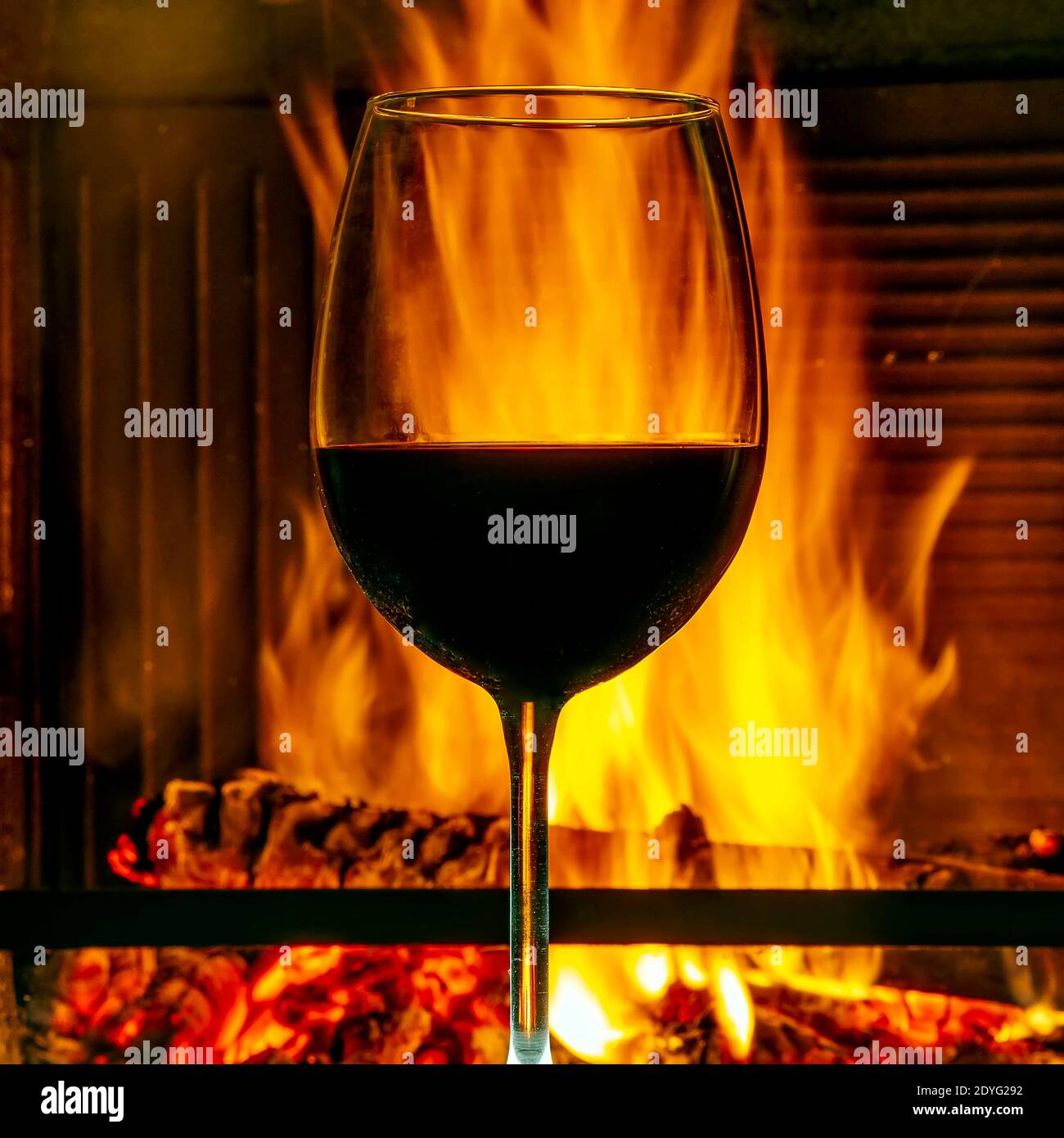 A glass of red tasting wine against a lit bonfire in a fireplace Stock ...