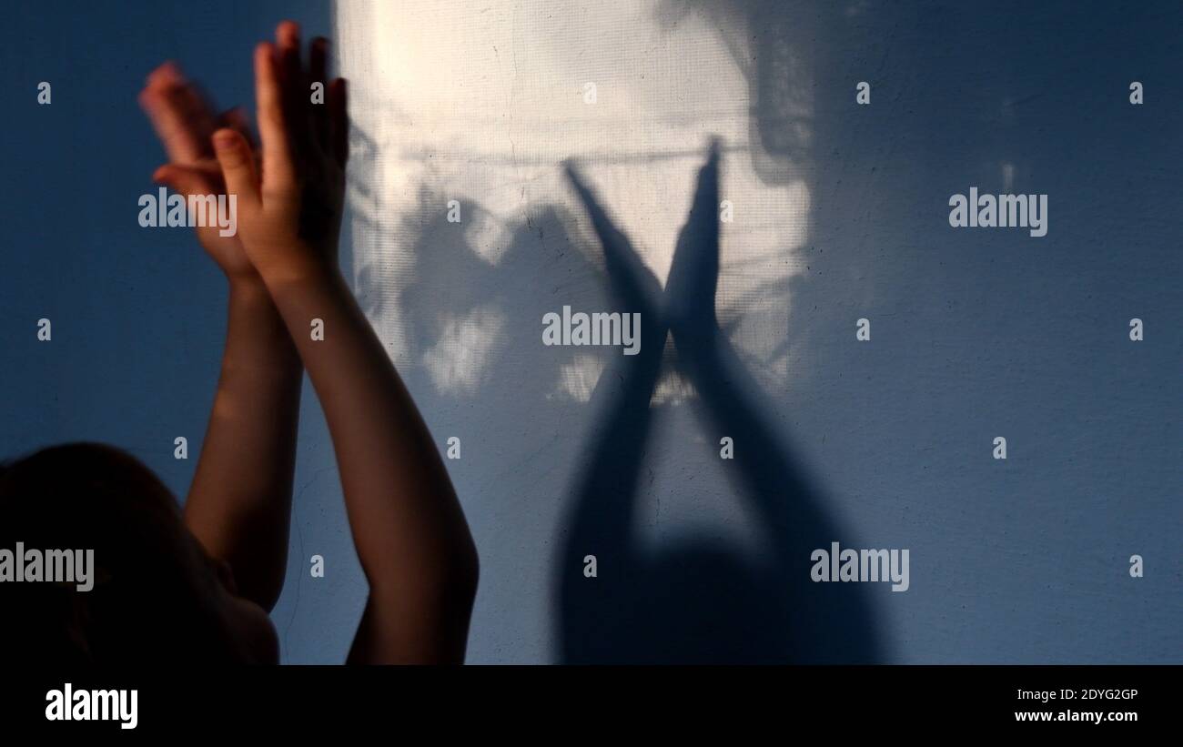 Child claps hands on unfocused foreground and focus to blurry hand ...