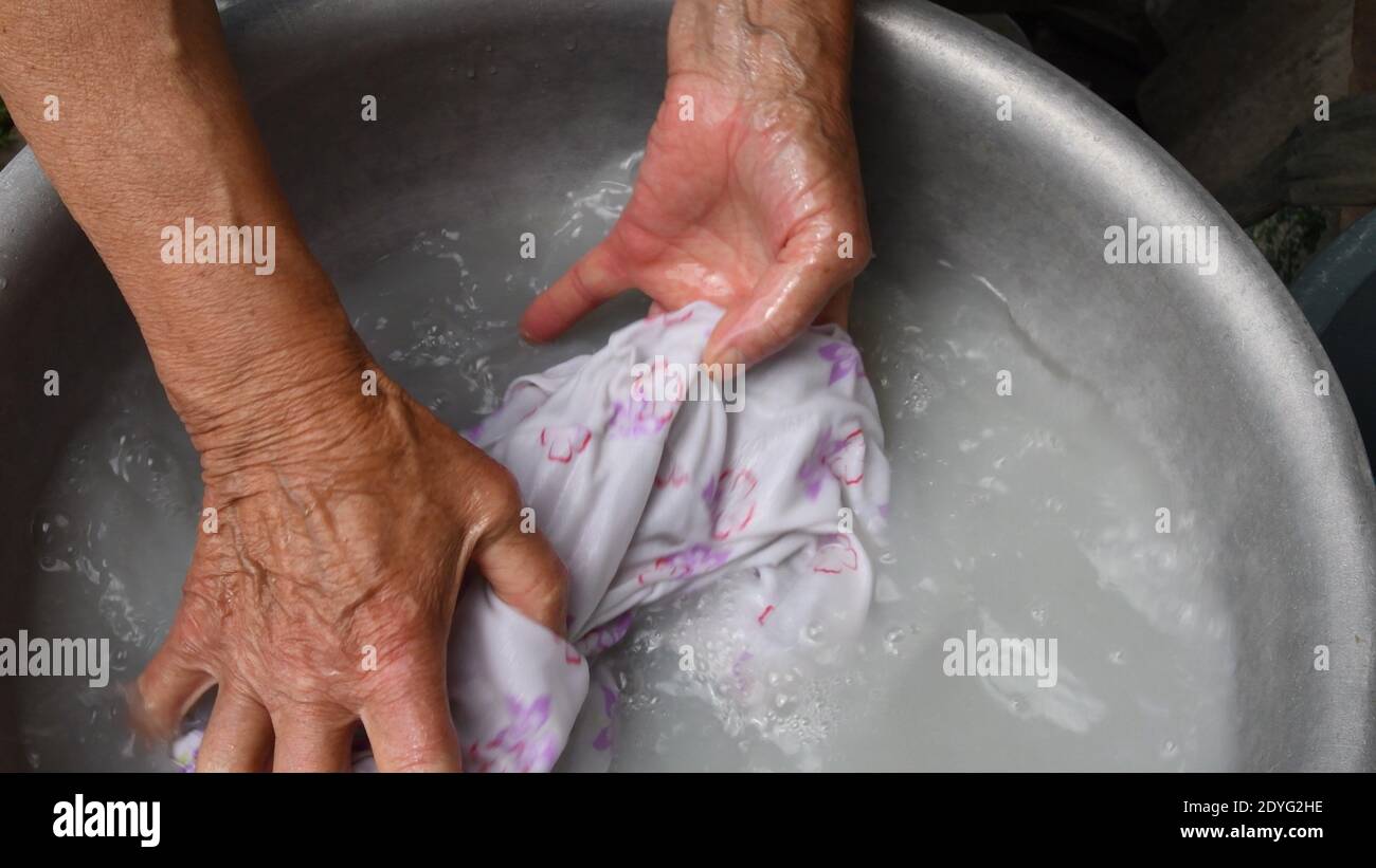 Hand washing clothes in bowl hi-res stock photography and images - Alamy