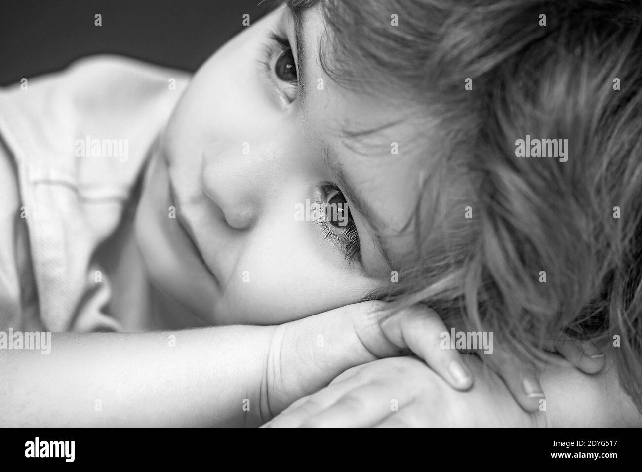 Little boy sitting at desk on classroom background Stock Photo - Alamy