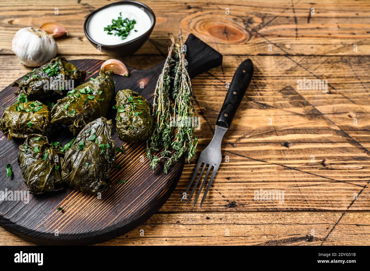 Traditional georgian dolma in grape leaves. wooden background. Top view ...
