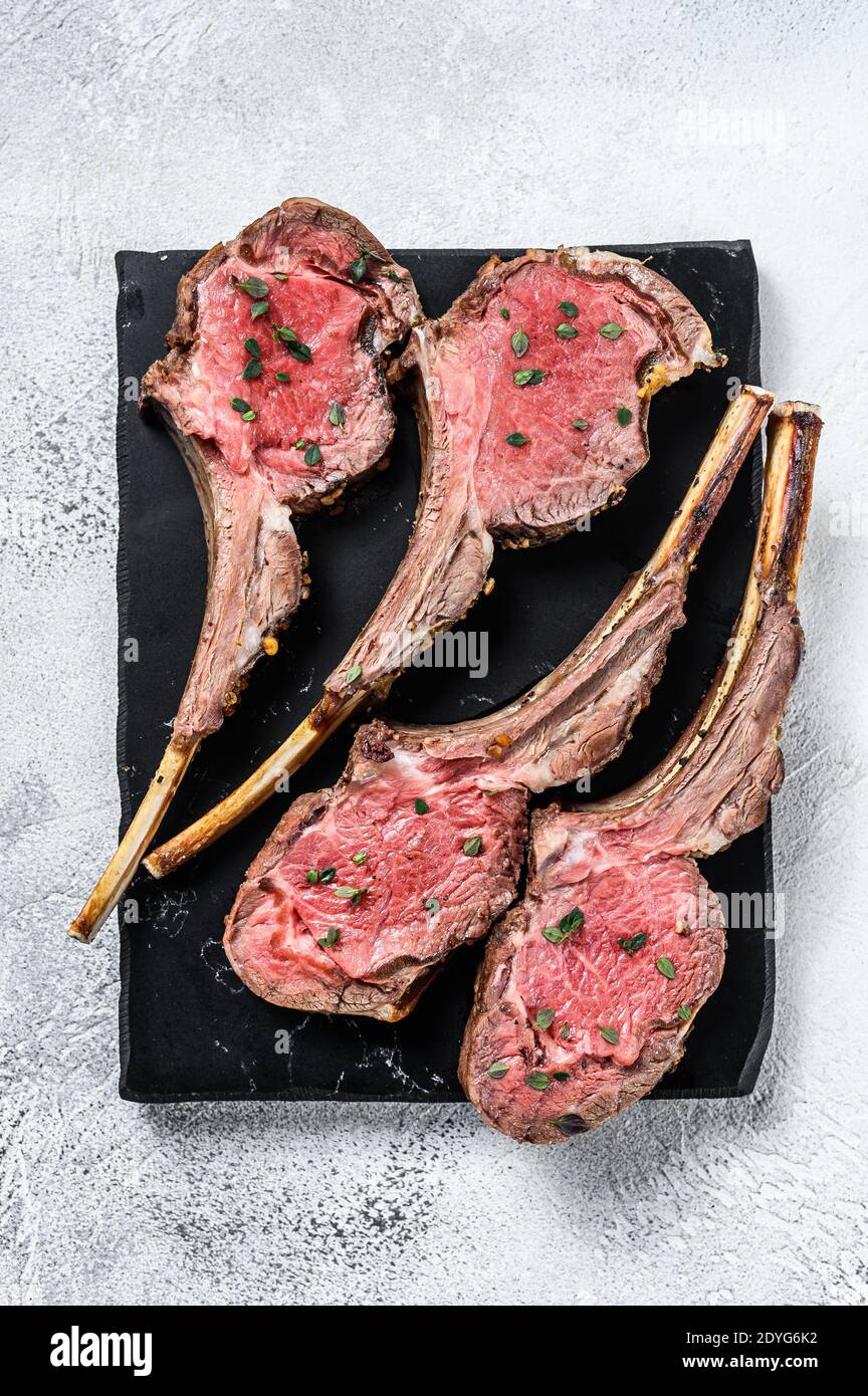 Baked lamb chop meat steaks. White background. Top view Stock Photo - Alamy