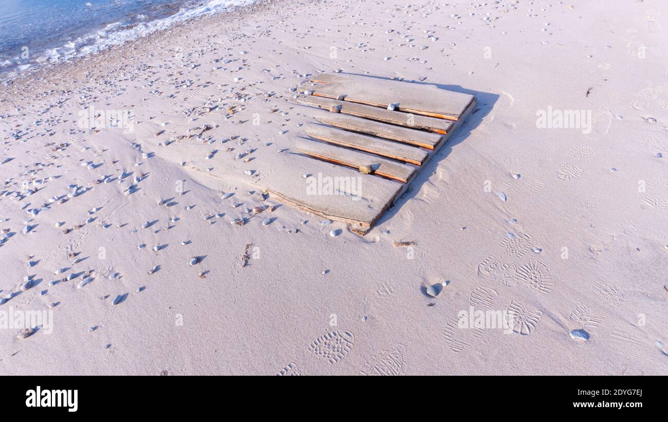 A high angle shot of a wooden platform buried in the sand Stock Photo ...