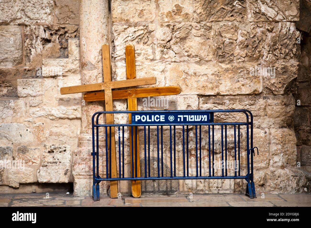 Christian crosses behind police barriers are leaning against the wall ...