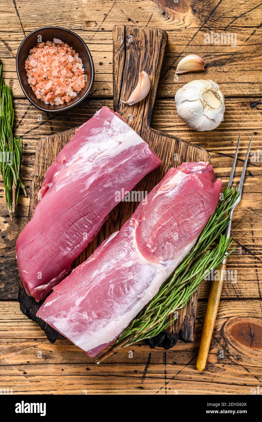 Raw cut pork tenderloin fillet meat. wooden background. Top view Stock ...