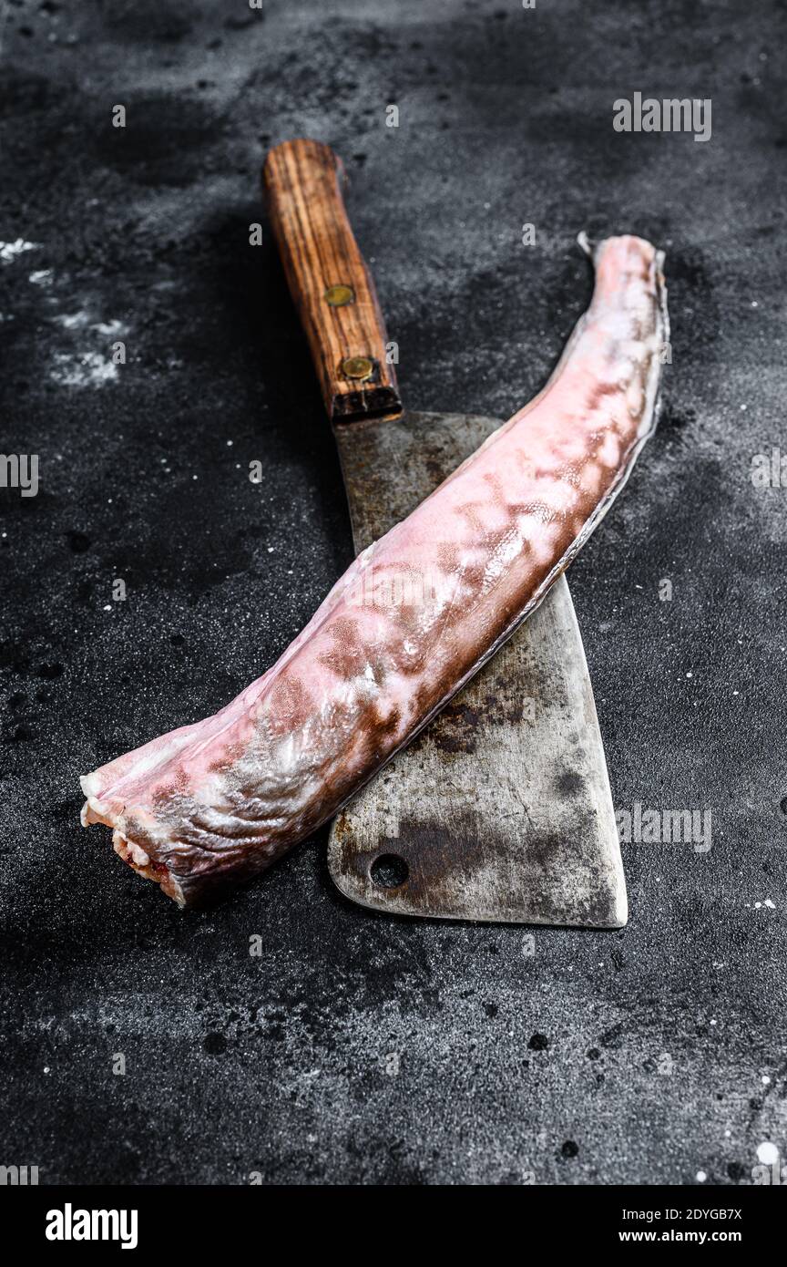 Raw king klip, congrio fish on a cleaver. Black background. Top view ...