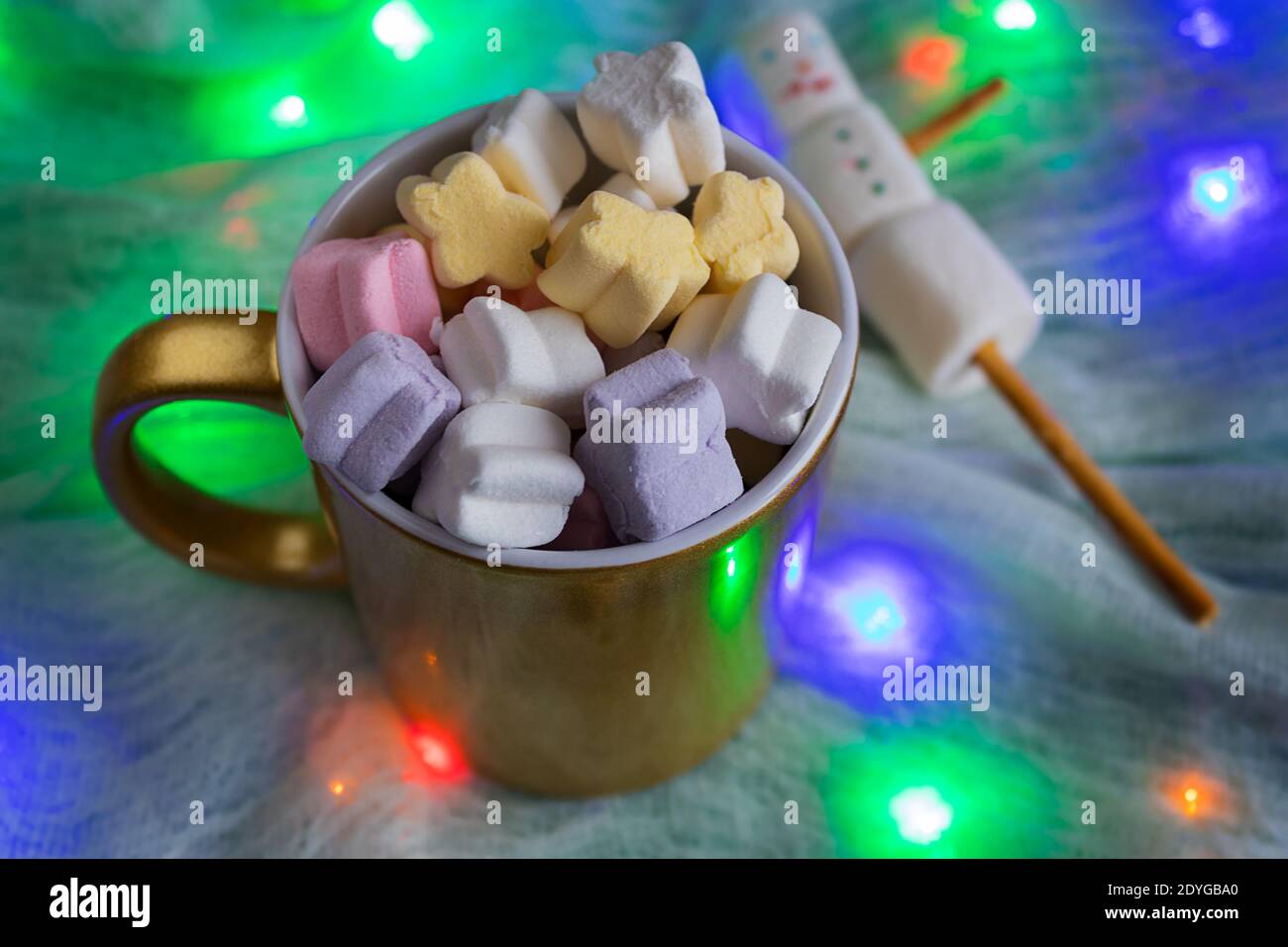 Marshmallow in the cold mug. Marshmallow made as snowman on the side ...