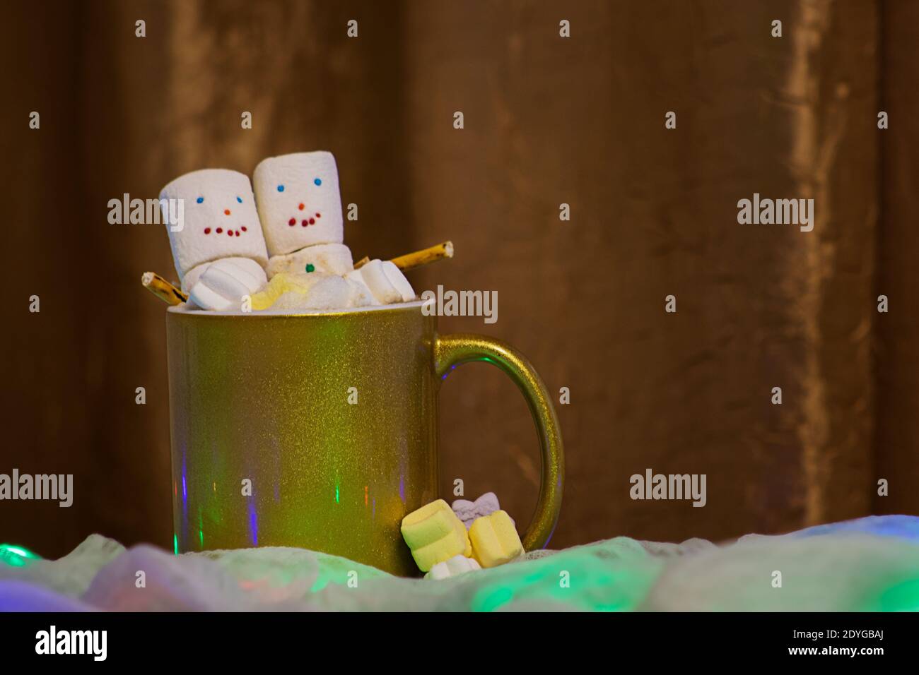 Mashmallow is made as snowman. Gold cup of cappuchino with marshmallow ...