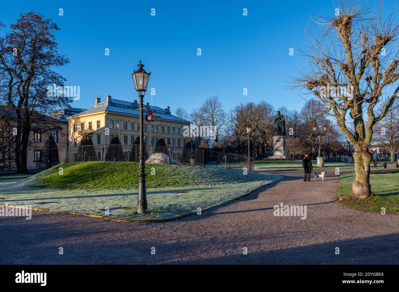 Unrecognizable person in Carl Johans park with the statue of king Karl ...