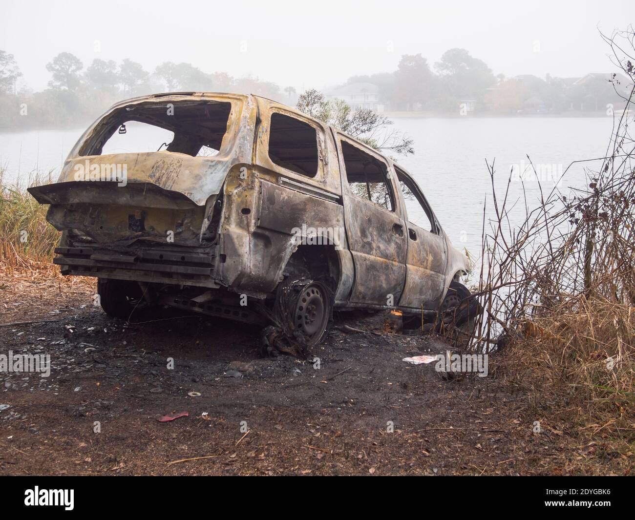 Burned car at the edge of the river Stock Photo - Alamy