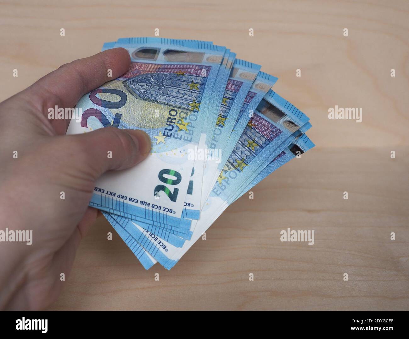 Hand holding Euro banknotes money (EUR), currency of European Union ...