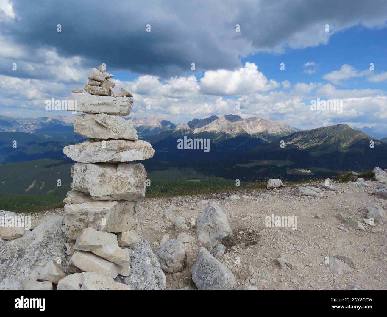 A closeup of stones stacked on each other, the scenic Dolomite Alps in ...