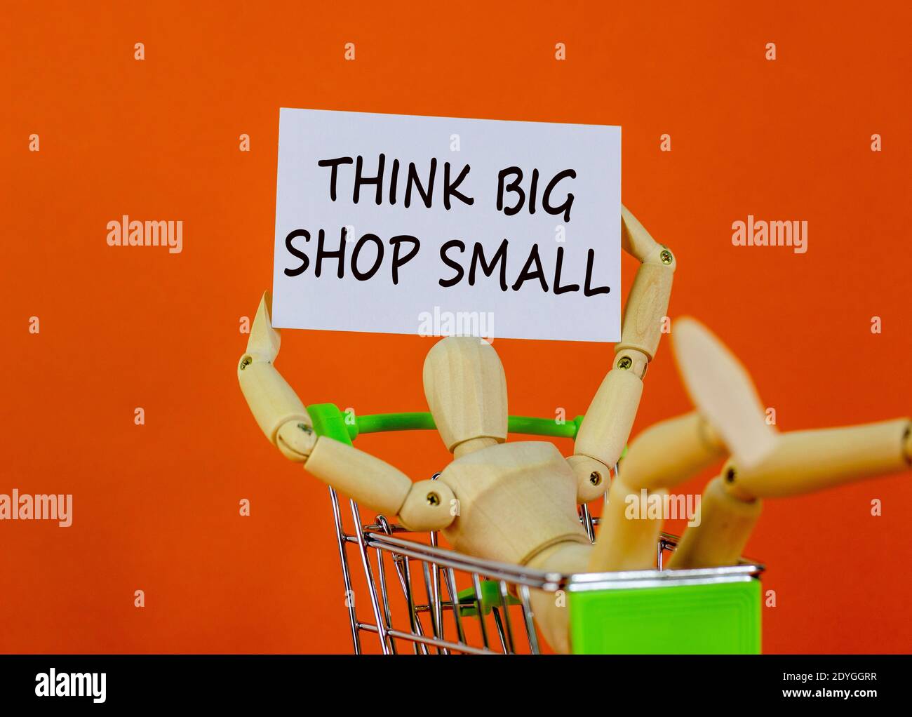Think big shop small symbol. White sheet of paper. Words 'Think big ...
