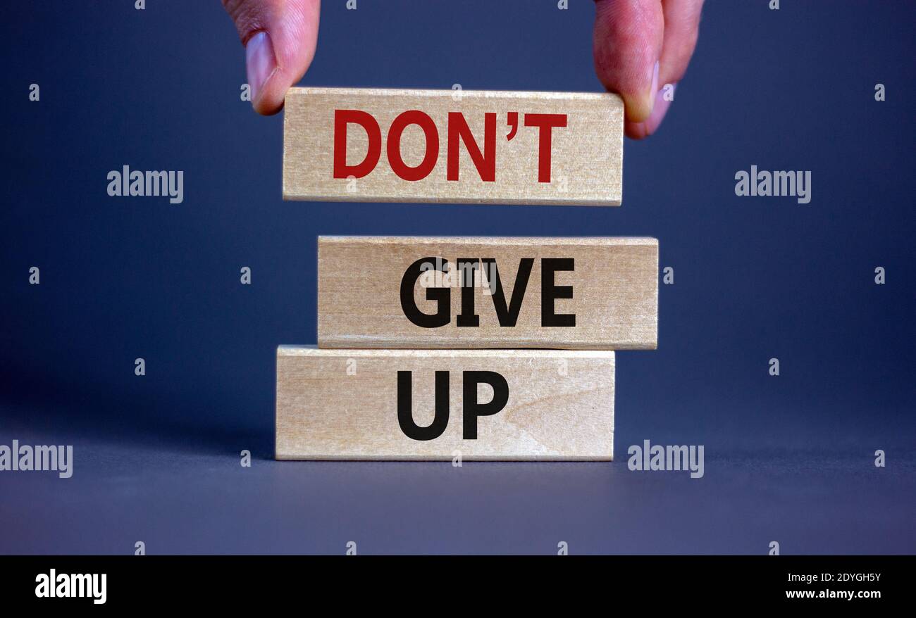 Do not give up symbol. Wooden blocks with words 'do not give up ...
