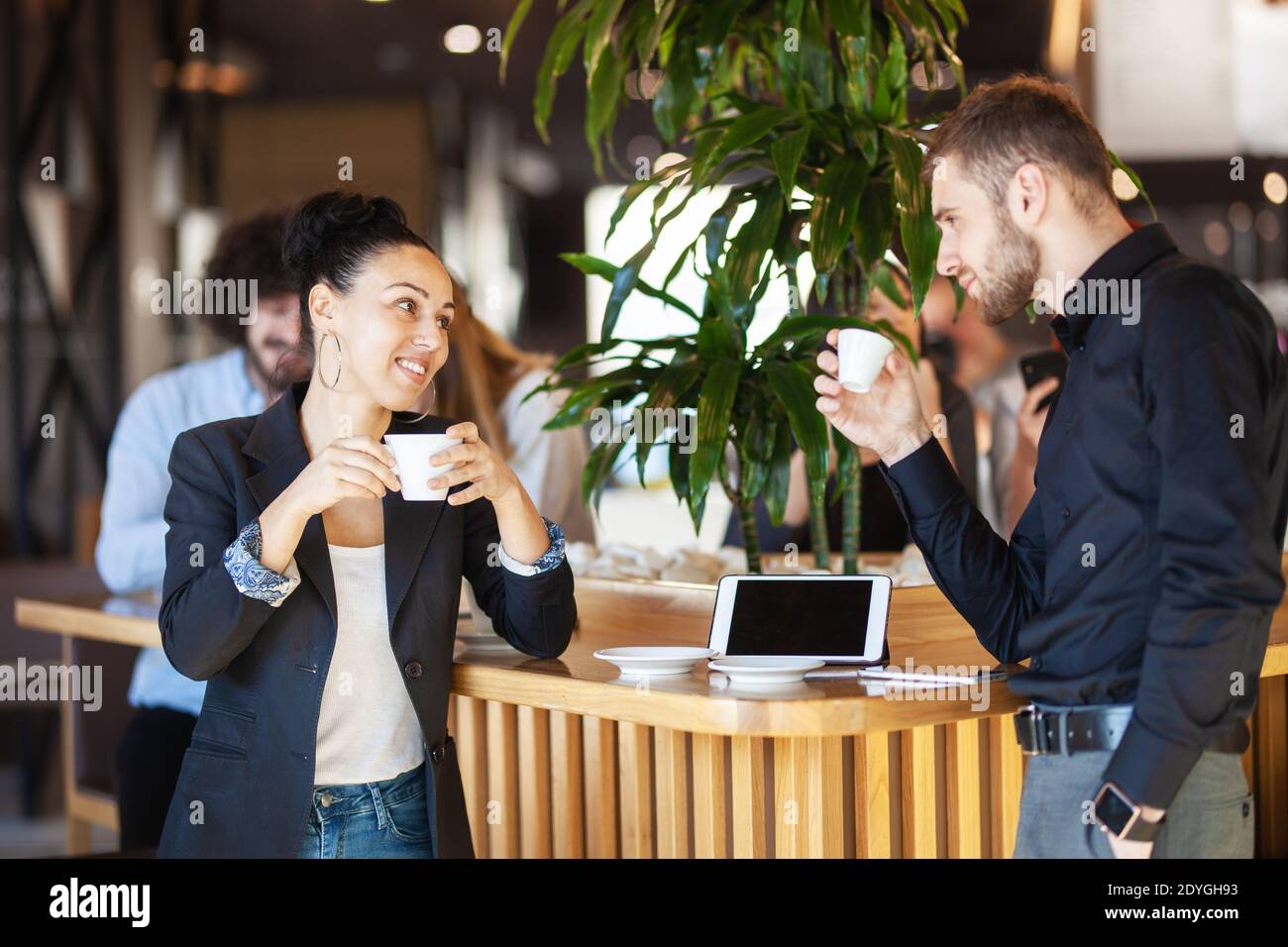 Colleagues having a coffee and conversation in a cafe Stock Photo - Alamy